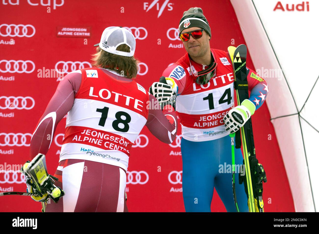 Winner Kjetil Jansrud of Norway, left, shakes hands with third-place ...