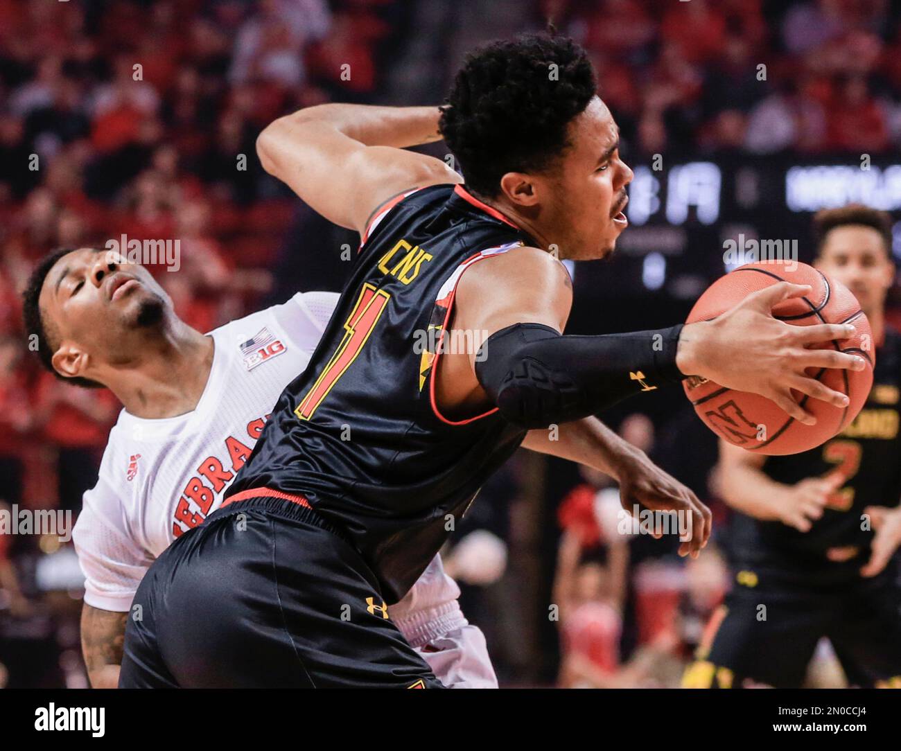 Maryland's Jared Nickens (11) drives around Nebraska's Benny Parker (32 ...