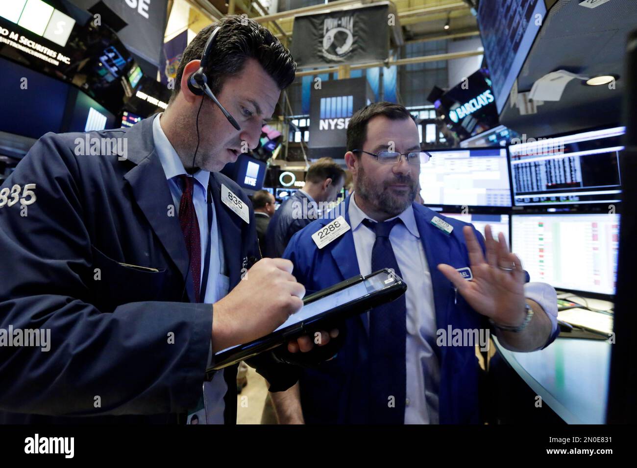 Trader Glenn Kessler, left, and specialist Michael McDonnell work on ...