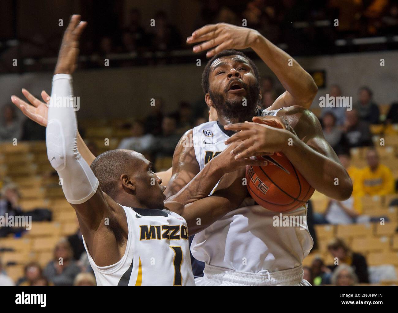 Missouri's Kevin Puryear, right, pulls down a rebound in front of ...