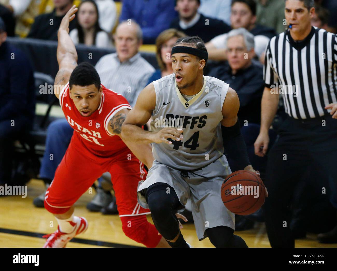 Colorado guard Josh Fortune, right, drives for a shot past Utah forward ...