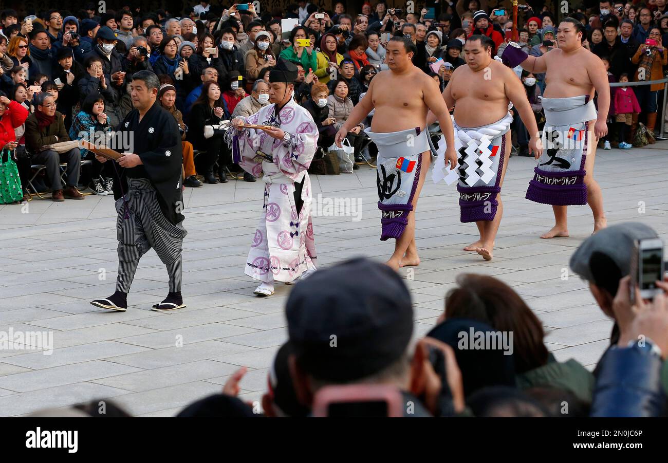 Sumo grand champion Kakuryu, second right, of Mongolia arrives to ...