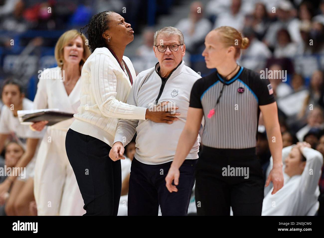UConn head coach Geno Auriemma is held back by assistant coach Jamelle ...