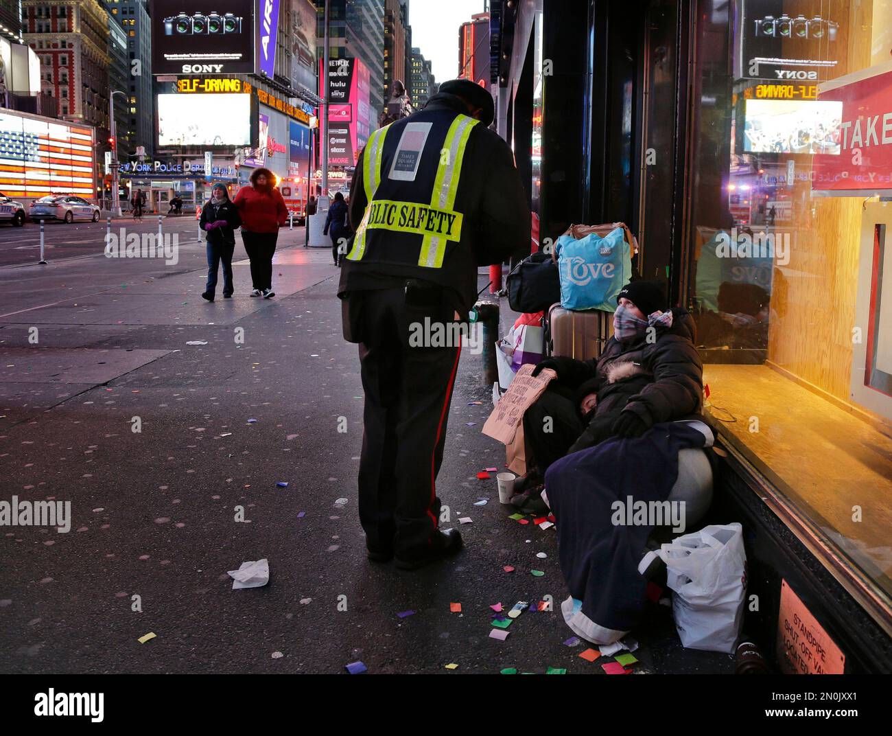 A Time Square public safety officer talks to a homeless couple, Monday ...