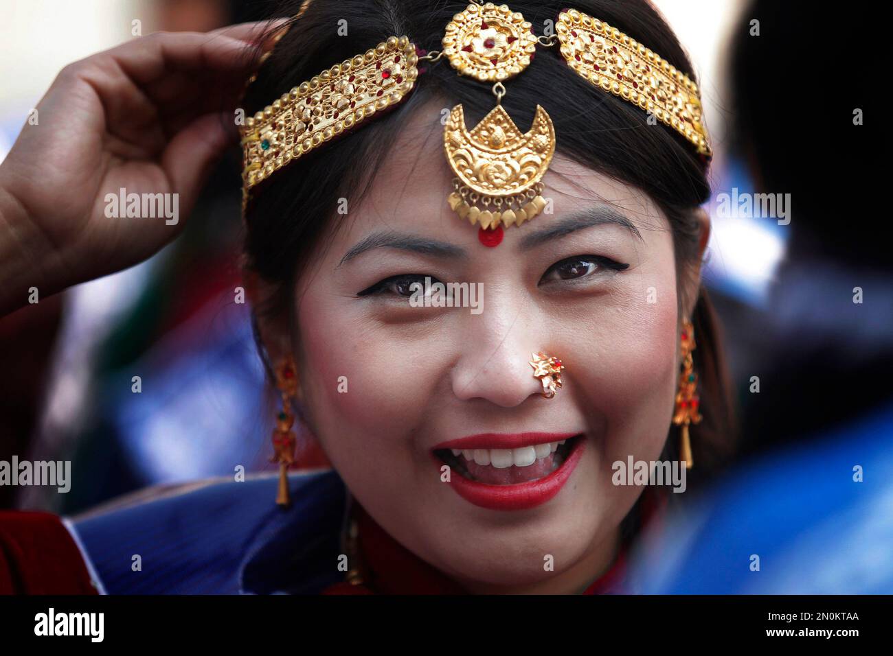A Nepalese Gurung community woman wearing traditional attire smiles as ...
