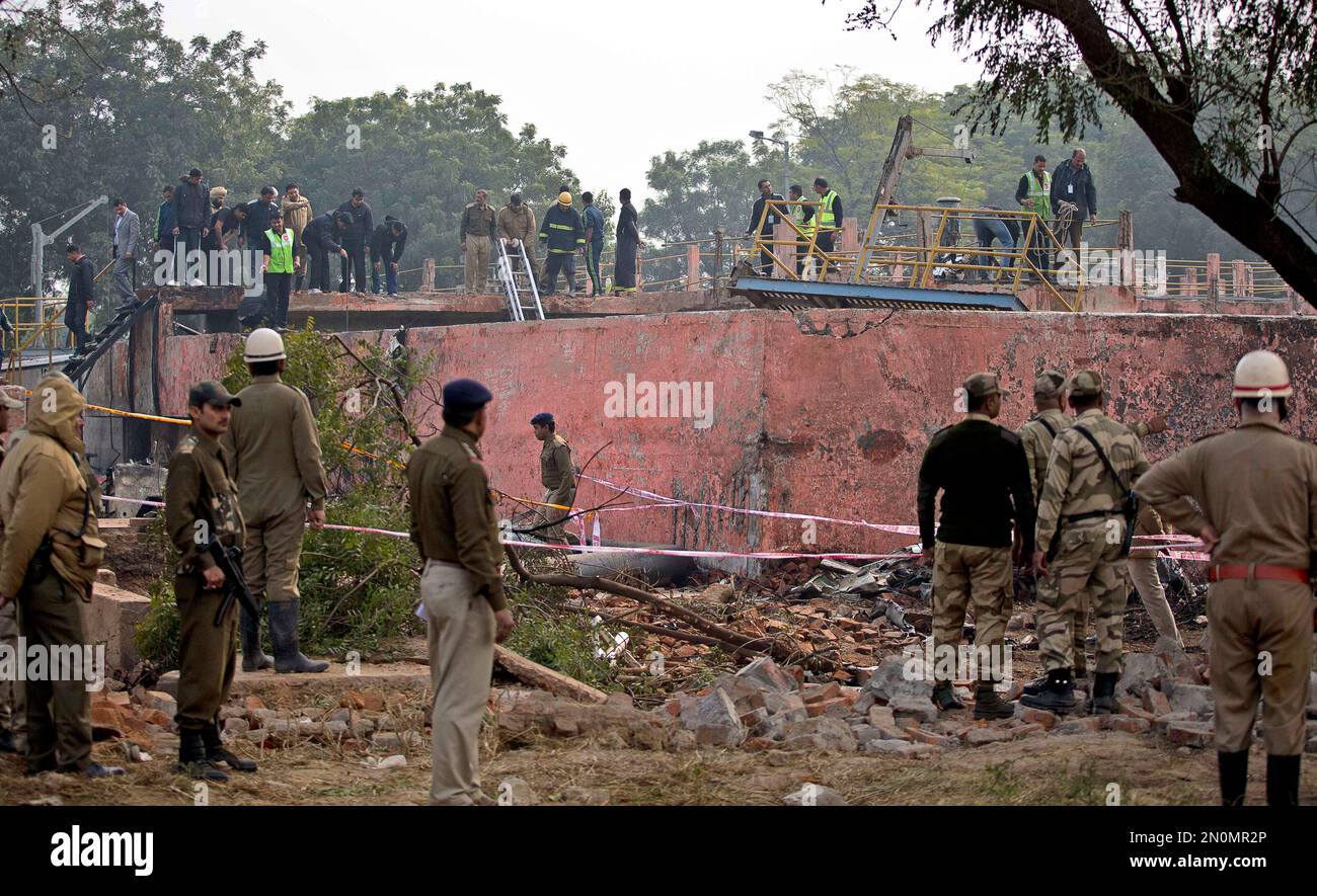 As Indian security personnel cordon off the area, investigators inspect ...