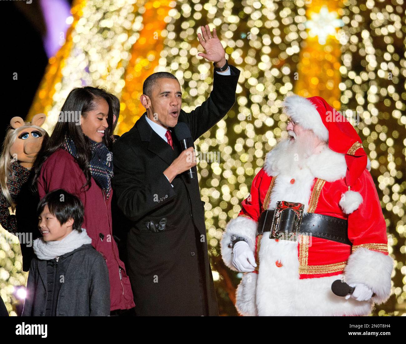 President Barack Obama, center, waves to the crowd as he walks off ...
