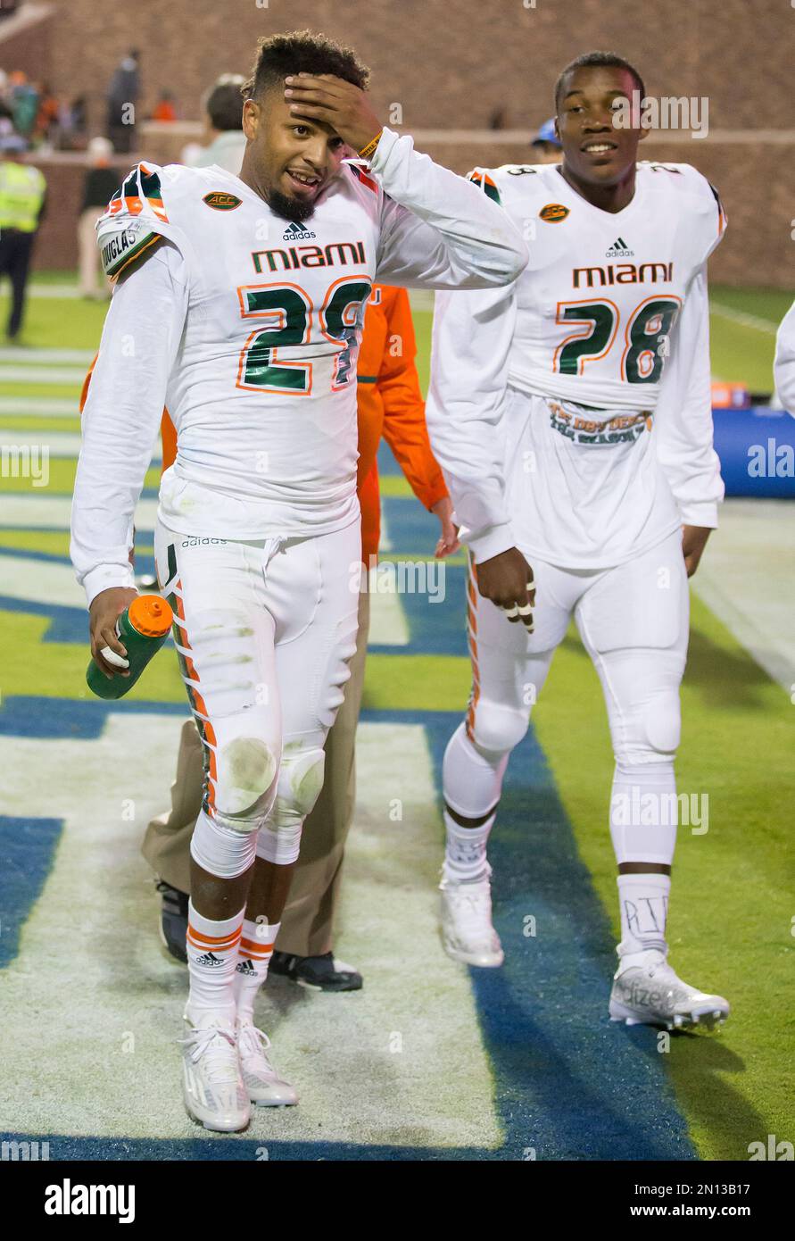 Miami's Corn Elder (29) wipes his head as he leaves the field following ...