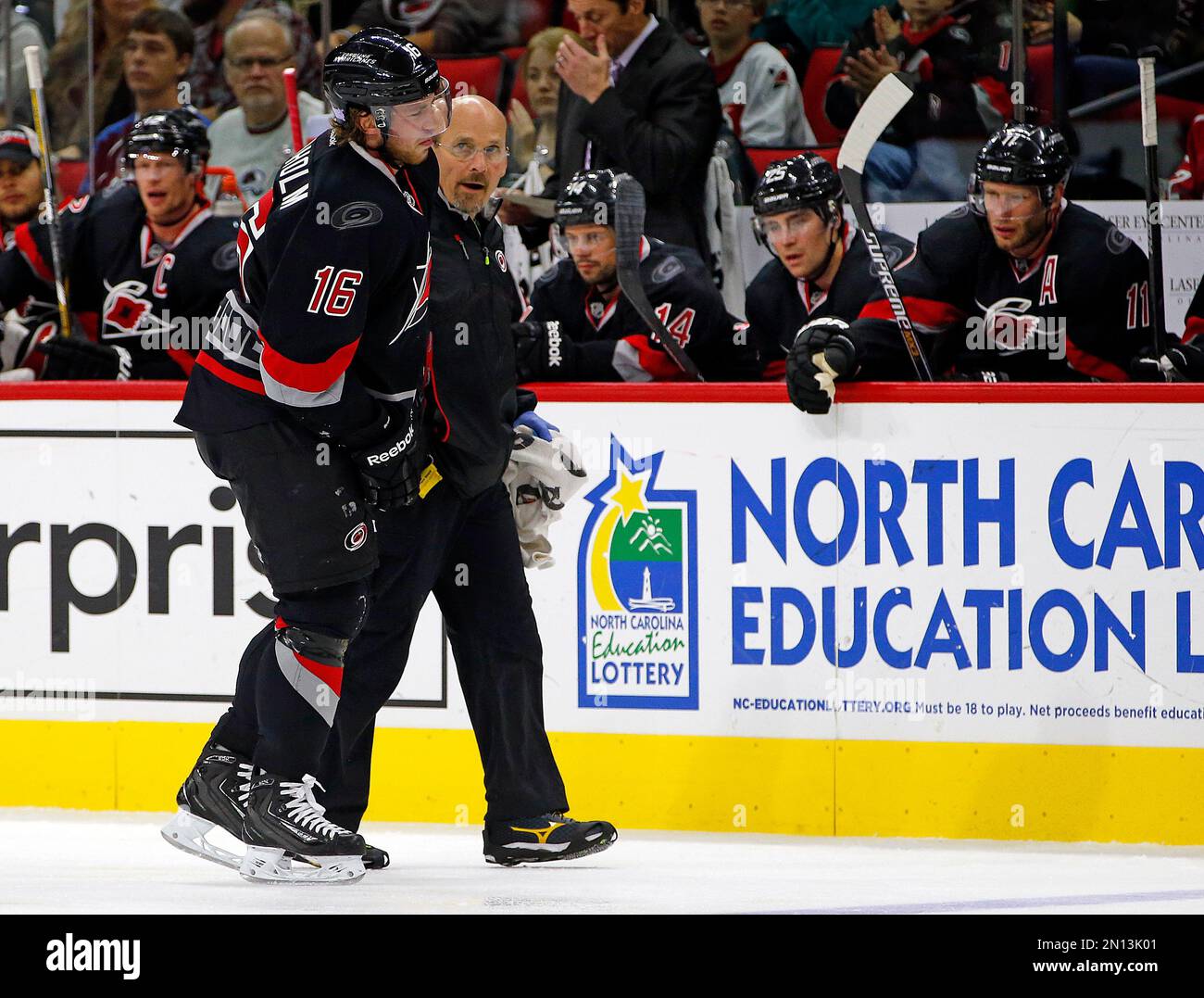 Carolina Hurricanes' Elias Lindholm (16), of Sweden, is assisted from ...