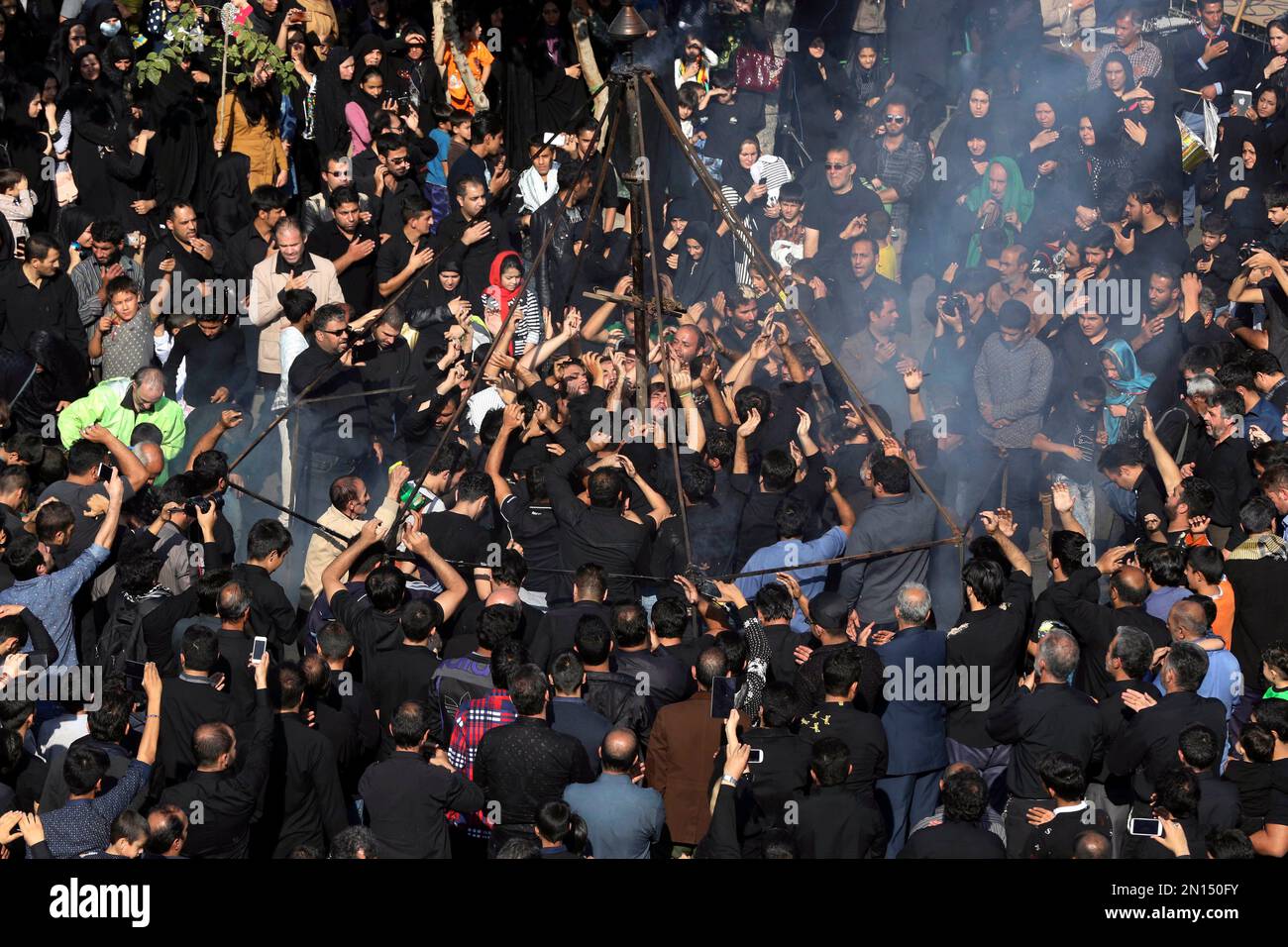 Iranian mourners symbolically beat themselves at a re-enactment of the ...