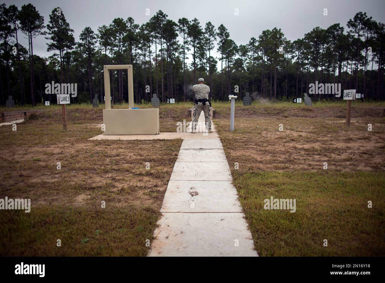 A member of the 139th Military Police Company shoots his 9mm Beretta M9 ...