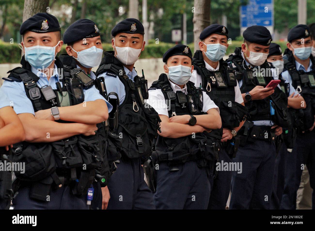Policemen wearing face masks stand guard outside the West Kowloon ...