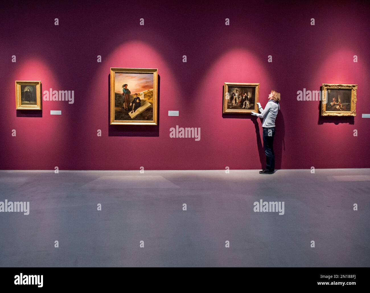 A museum worker adjusts the painting 'Tasso in the Madhouse' (1824) by ...