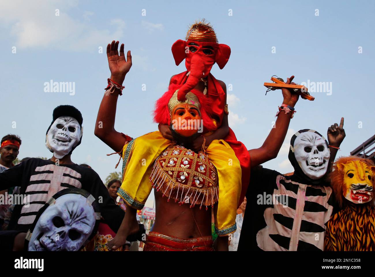 Indian Hindu youth wearing masks dance as an idol of the elephant ...