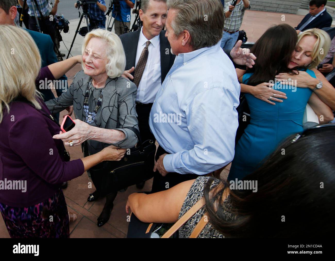 Yvonne Bertolet, second from left, hugs Lisanne Bales as her son, Barry ...