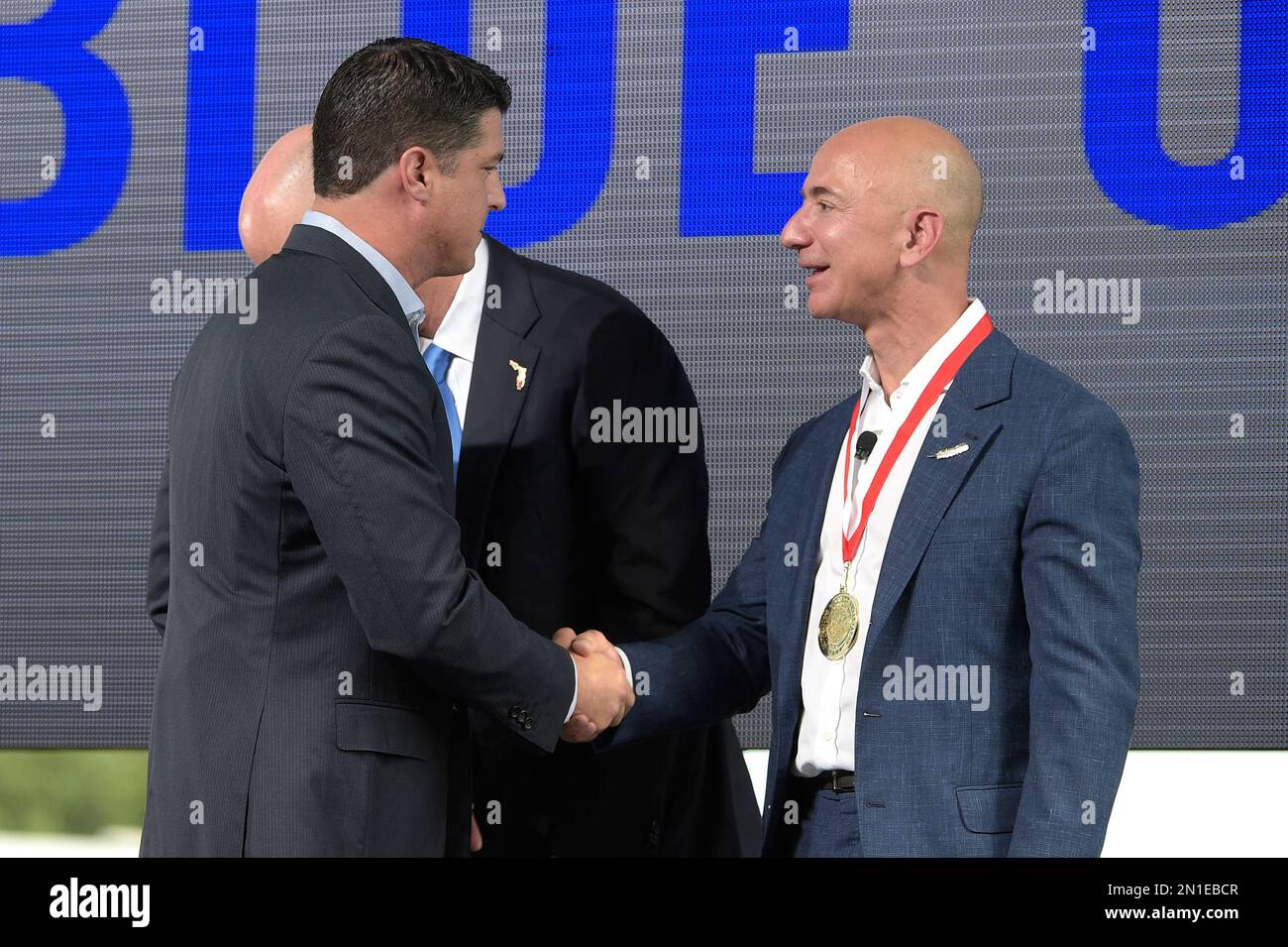 Amazon CEO Jeff Bezos, right, shakes hands with Florida House Speaker ...