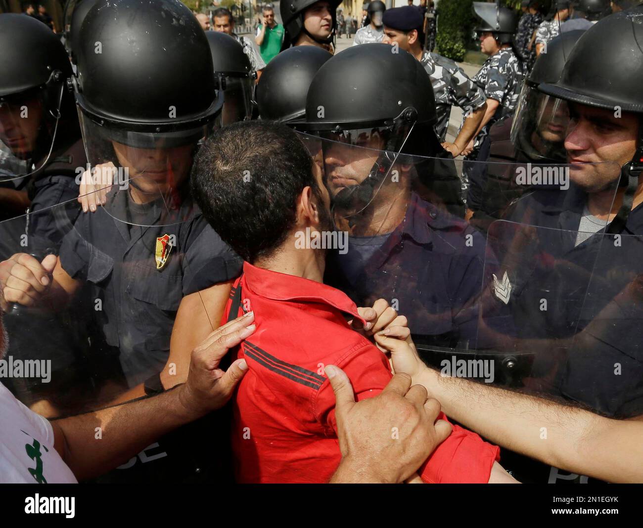Lebanese anti-government protesters clash with riot policemen on a road ...