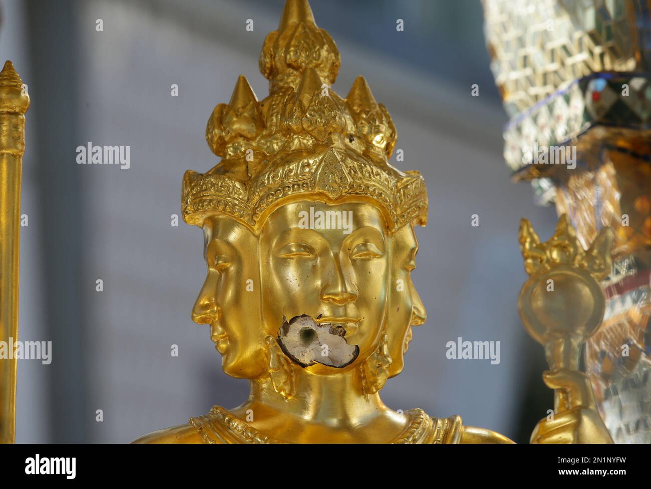 Damage is visible on the statue of Phra Phrom, which is the Thai ...