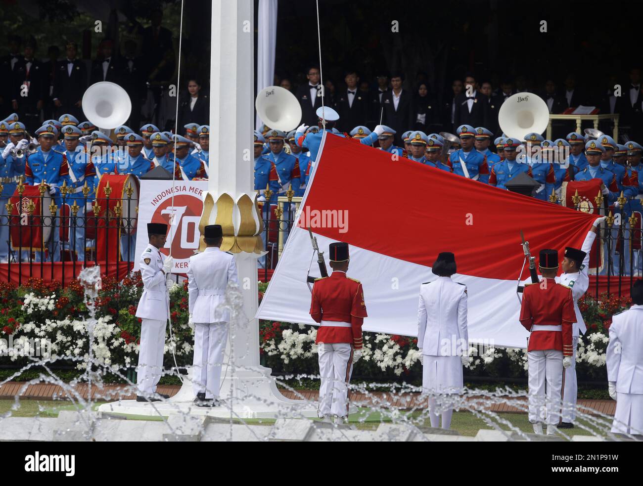 Flag bearers hoist an Indonesian national red-white flag during a ...