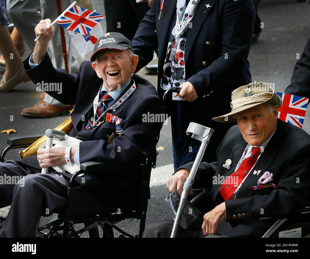 A veteran waves a flag during the parade to commemorate VJ day, as it ...
