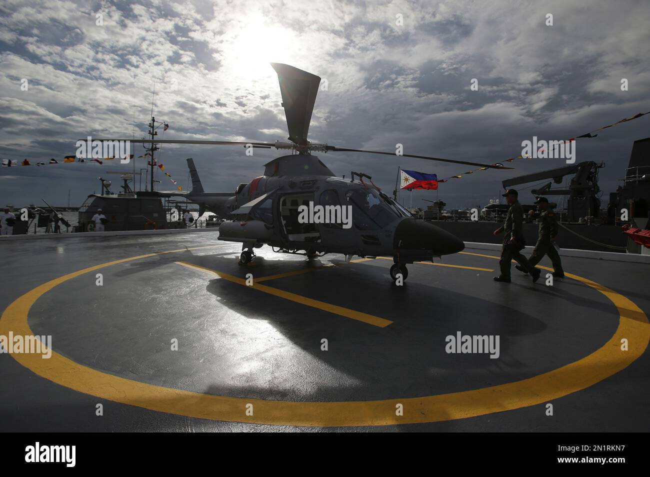 Members of the Philippine Navy walks toward an armed Agusta Westland ...