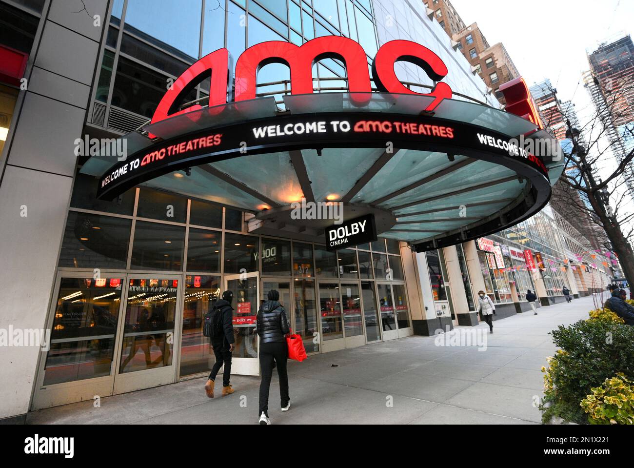 FILE - People walk by the AMC 34th Street theater on March 5, 2021, in ...
