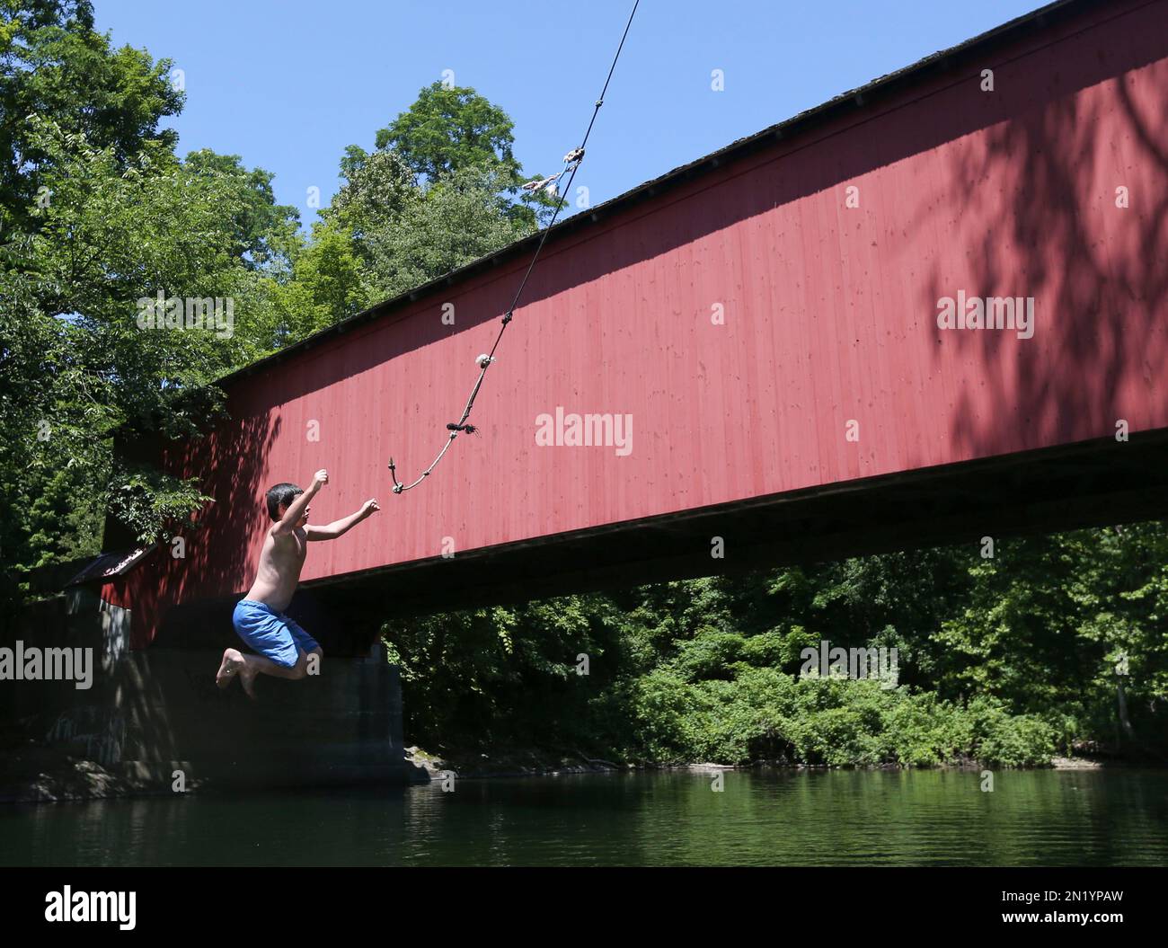 Colin Murray releases from a rope swing into the Battenkill River in ...
