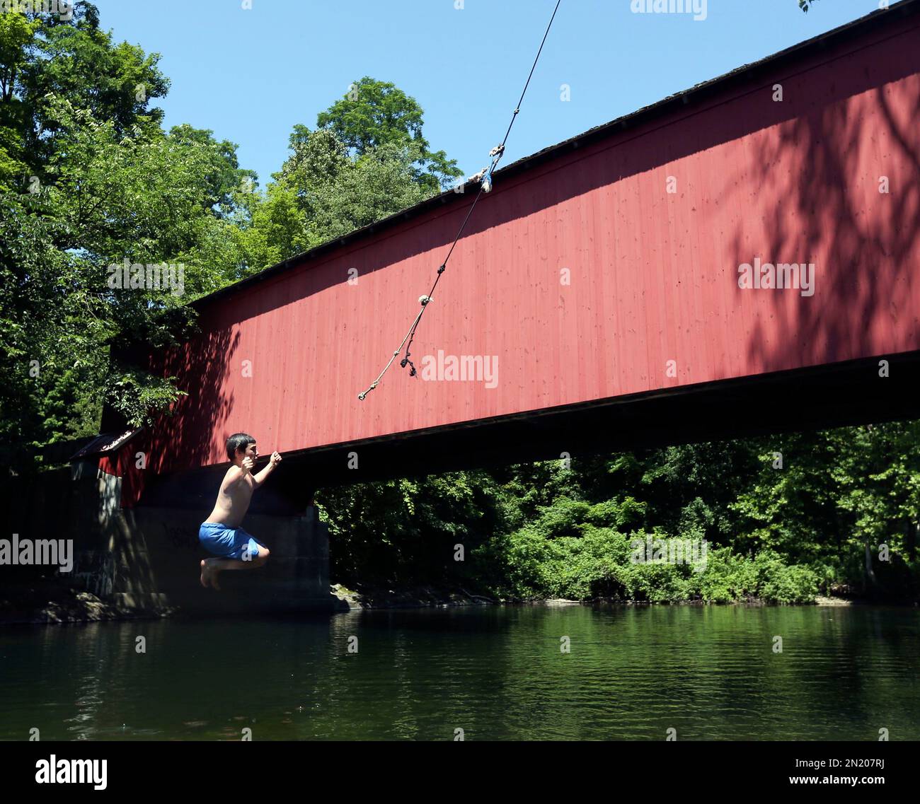 Colin Murray releases from a rope swing into the Battenkill River in ...