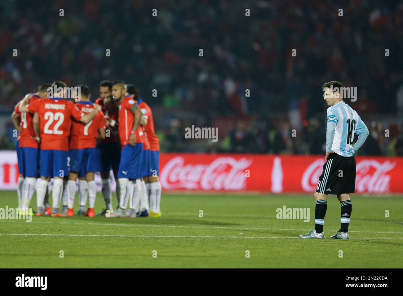 Argentina's Lionel Messi, right, stands as Chile's team meet, left ...