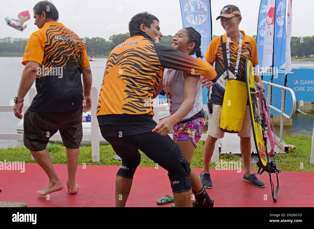 Malaysia's Aaliyah Yoong, 11, second right, gets a hug from her older ...
