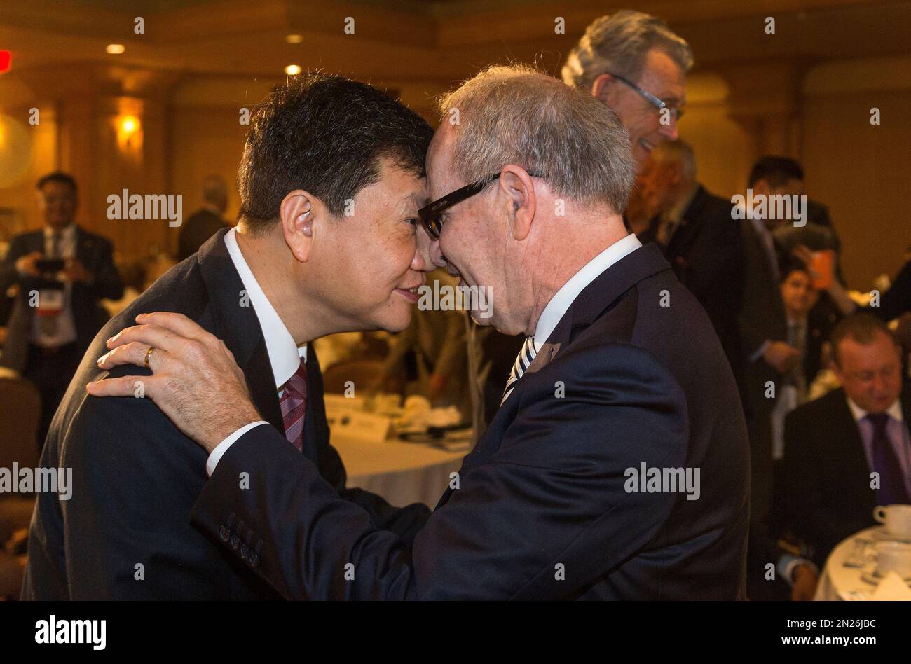 Mayor Chen Jianhua of Guangzhou, China, left, exchanges a hongi, the ...