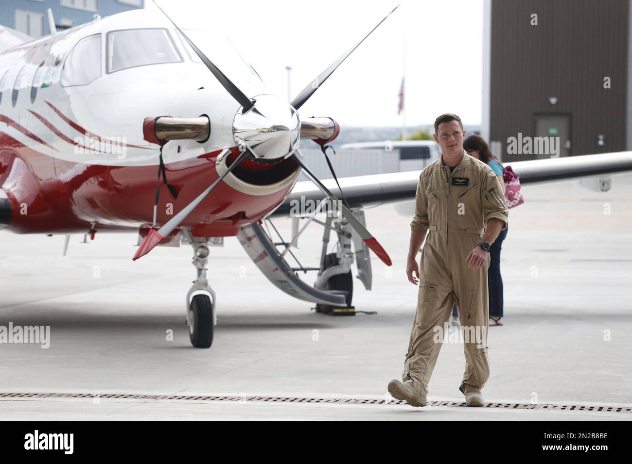 Pilot Scott Skelton, walks past the plane he flies, a Pilatus PC-12 ...
