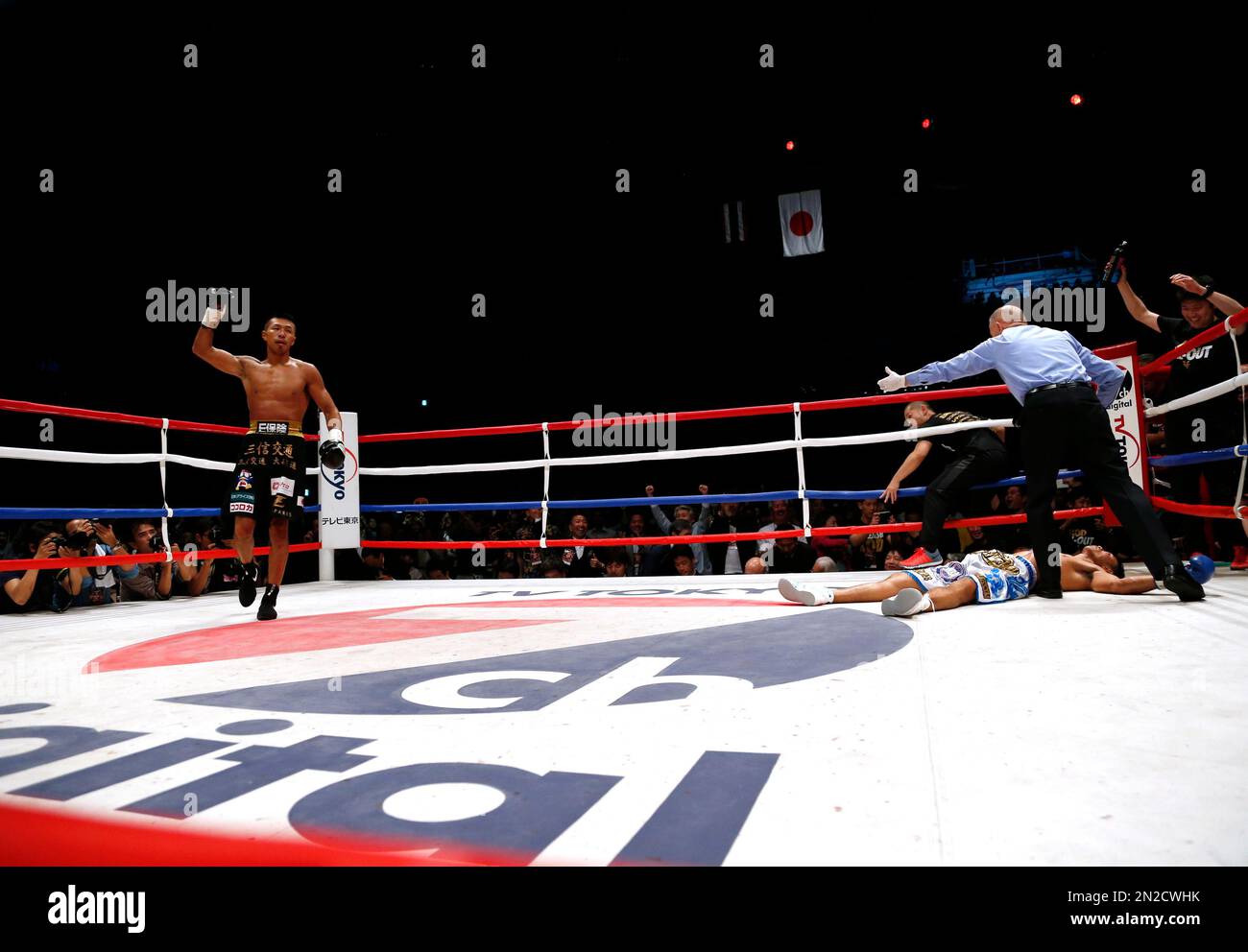 Japanese champion Takashi Uchiyama, left, celebrates after knocking out ...