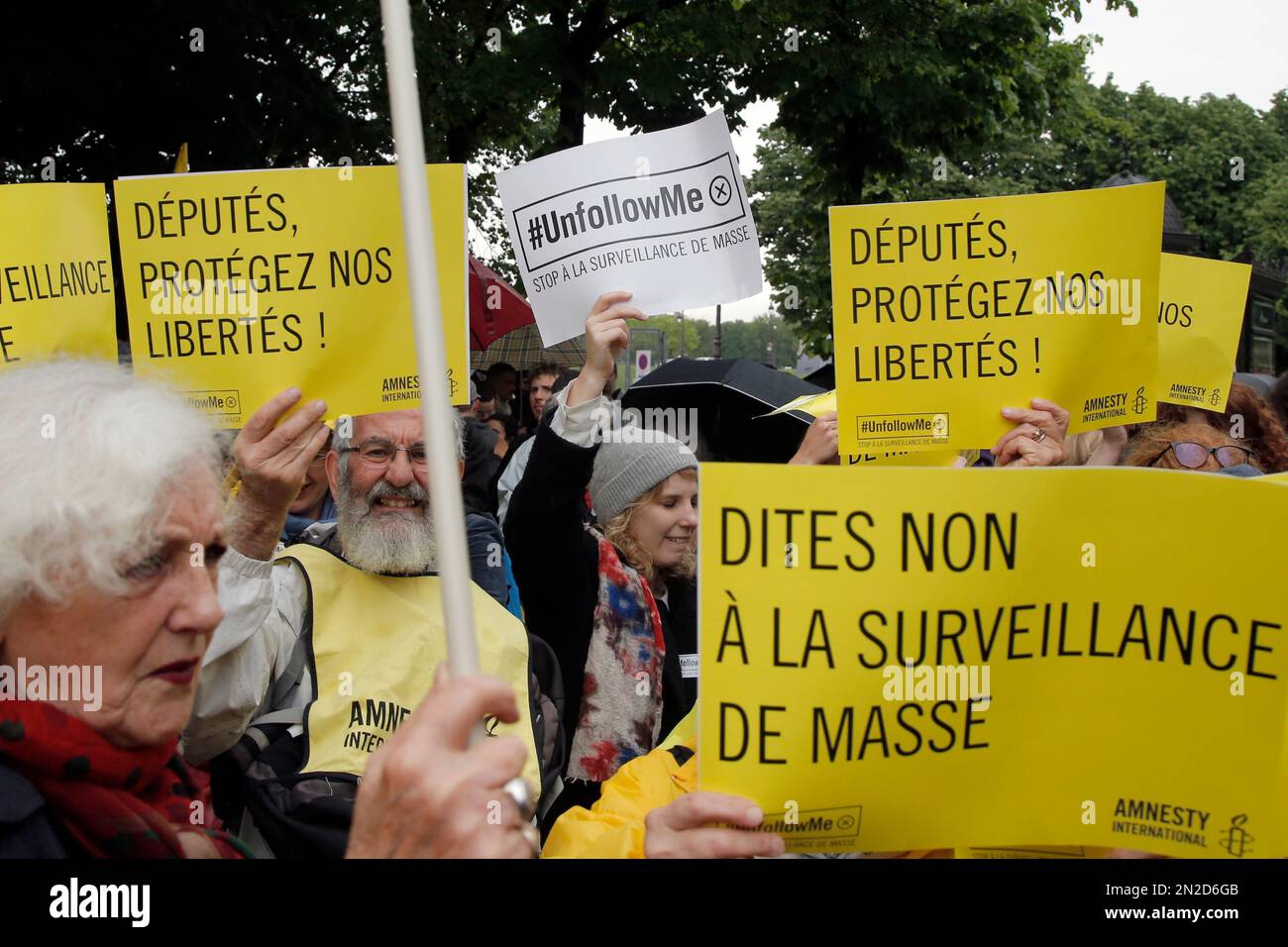 Demonstrators hold placards reading "Stop to Mass Surveillance", and ...