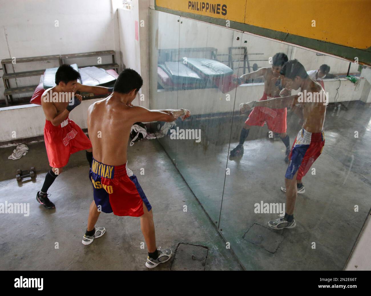 In this April 22, 2015, photo, Filipino boxer Rolly Macaso, left, and ...