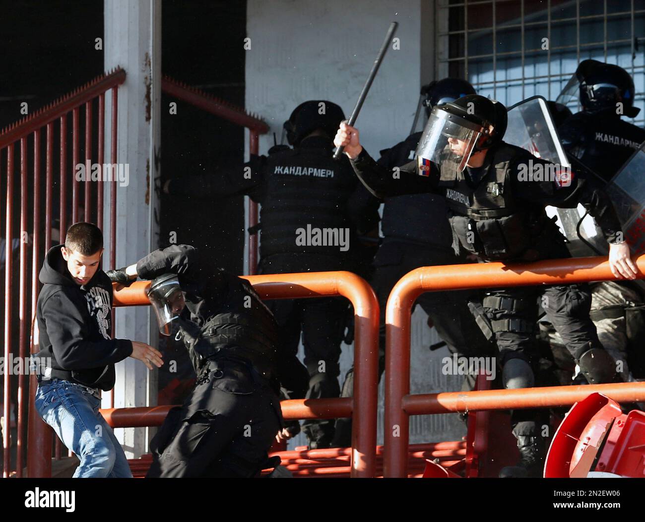 Serbian riot police officers clash with Red Star soccer fan during a ...