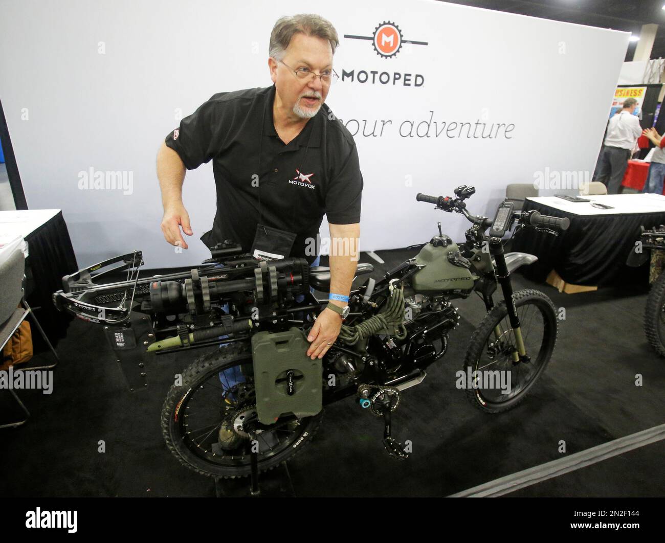 Ken Stone, left, with Motoped, demonstrates the Motoped Survival Bike ...