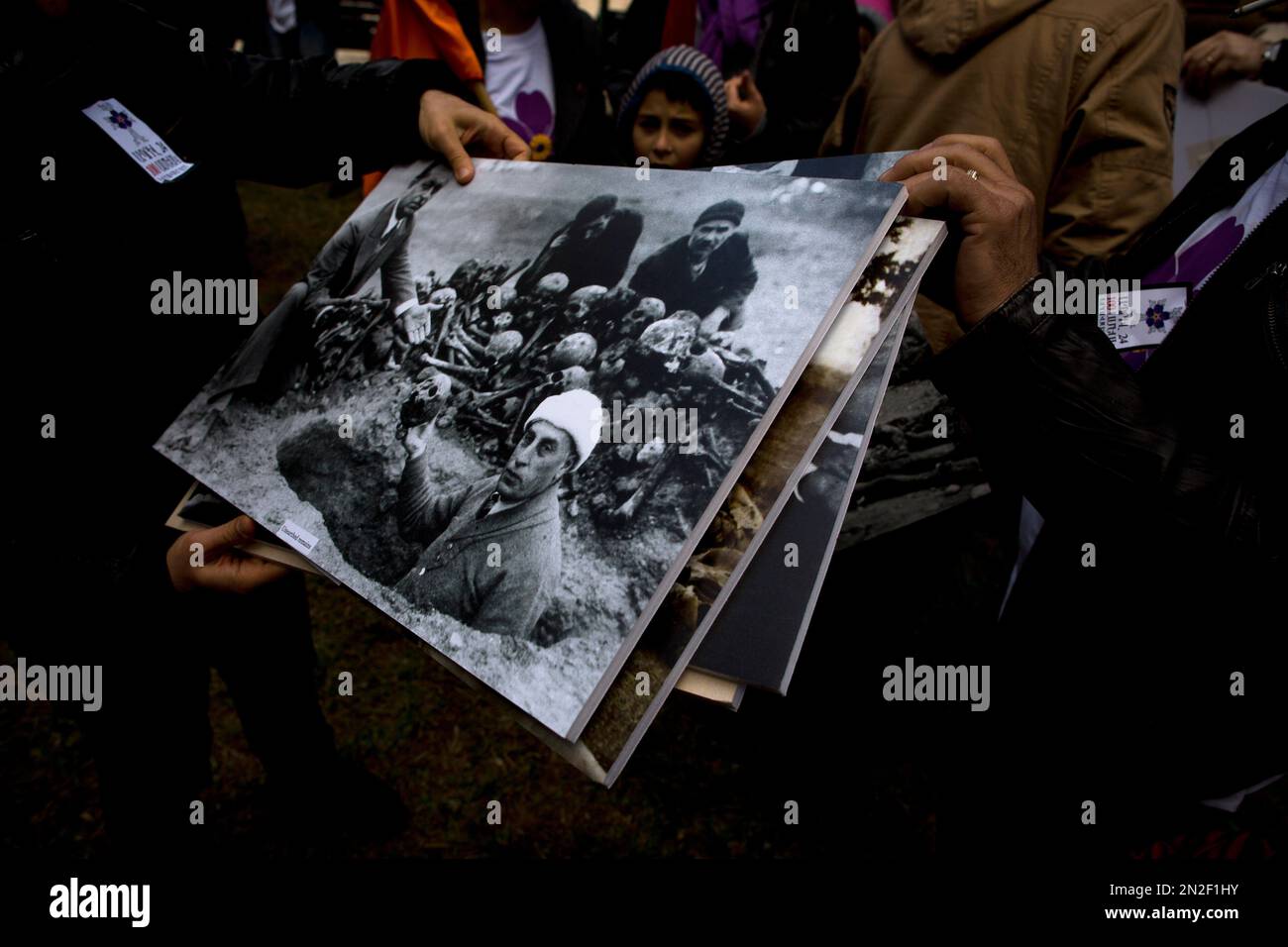 Armenians hold images from the Armenian Genocide during a ceremony to ...