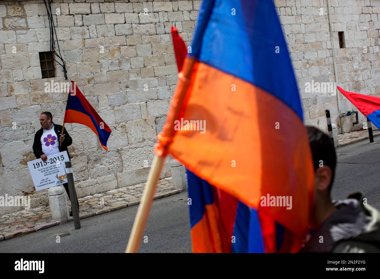 Armenians hold their national flag during a ceremony to commemorate the ...