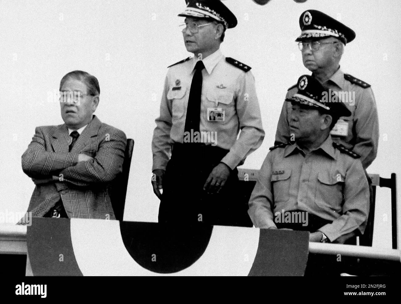 Nationalist Chinese President Lee Teng-hui, left, arms crossed, looks ...