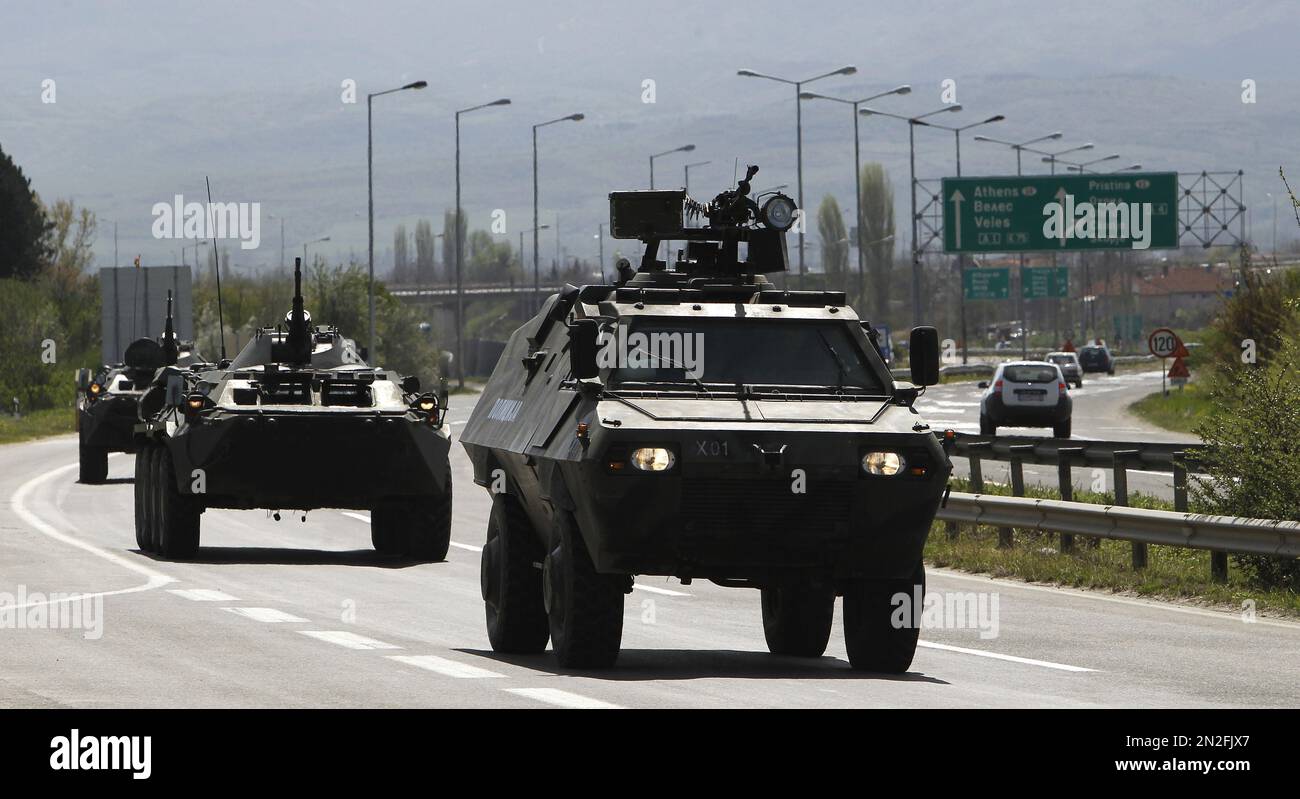 Police armored personal carriers move through a freeway northeast of ...