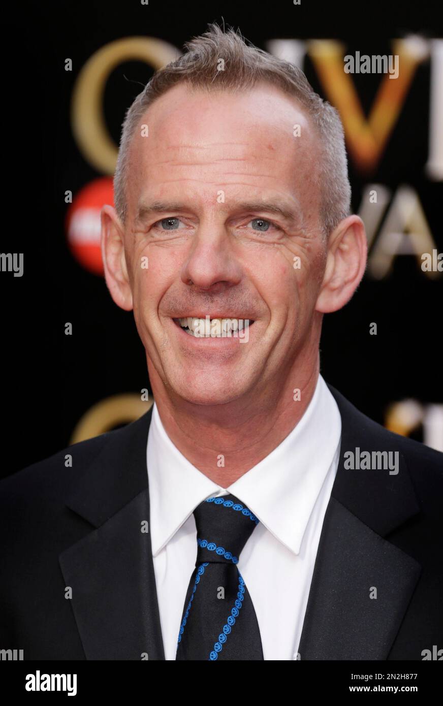 Norman Cook poses for photographers upon arrival at the Olivier Awards ...