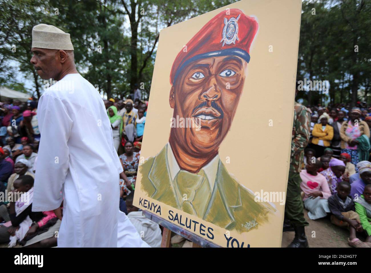 A mourner walks past a painting of Corporal Benard Kipkemoi Tonui, of ...