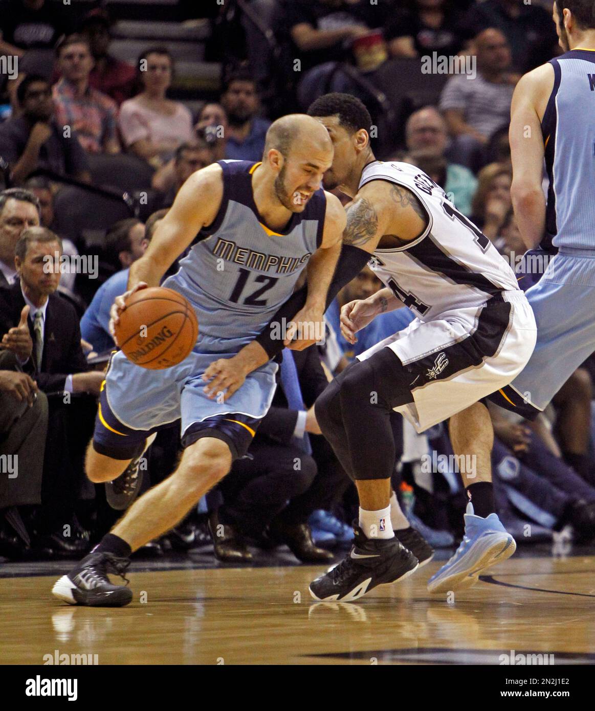 Memphis Grizzlies' Nick Calathes, left, drives around San Antonio Spurs ...