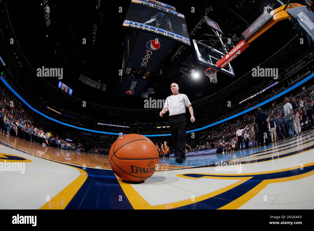 As viewed through a fisheye lens, a referee heads to pick up the ...
