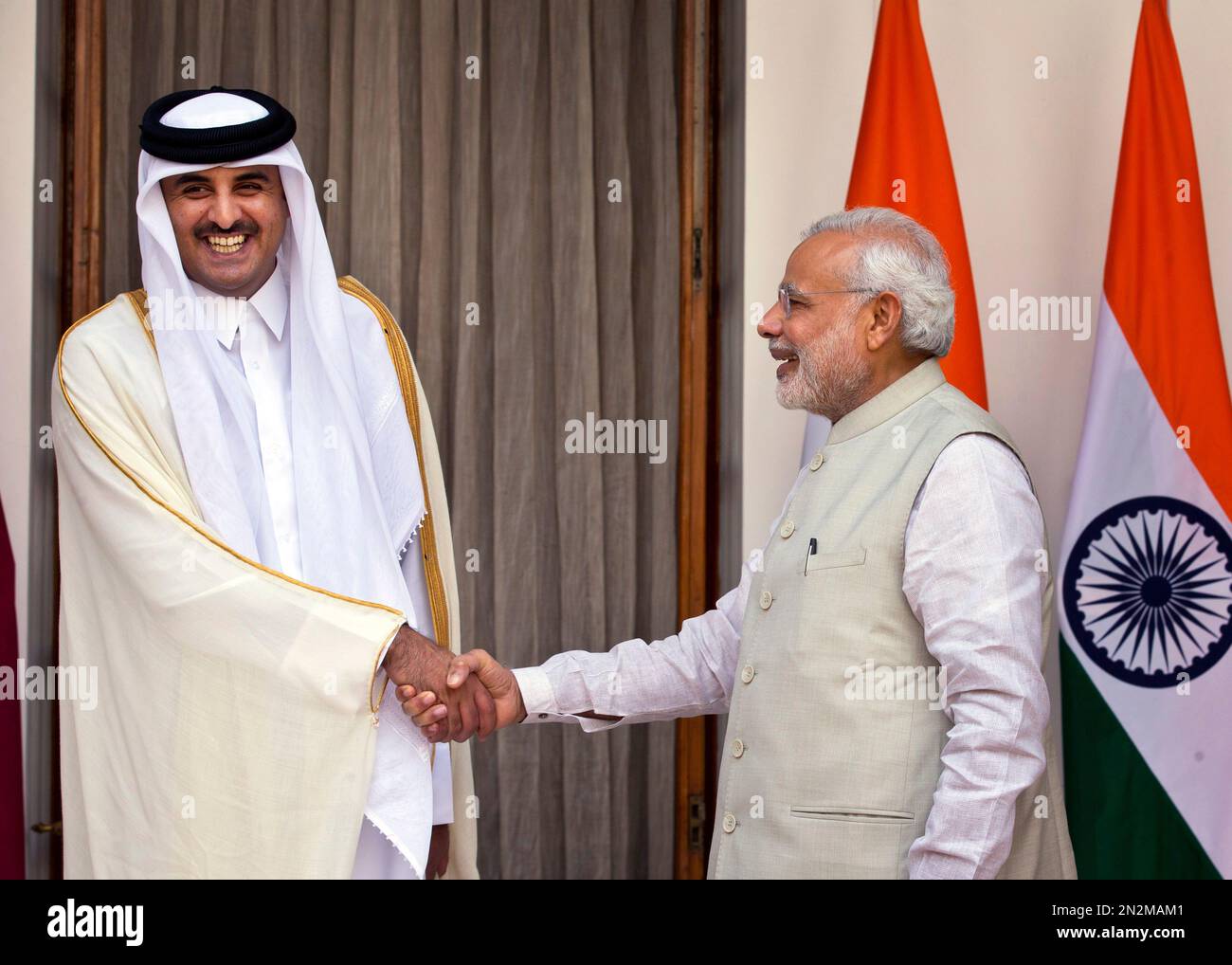 Qatar's Emir Sheikh Tamim bin Hamad Al-Thani, left, and Indian Prime Minister Narendra Modi ...
