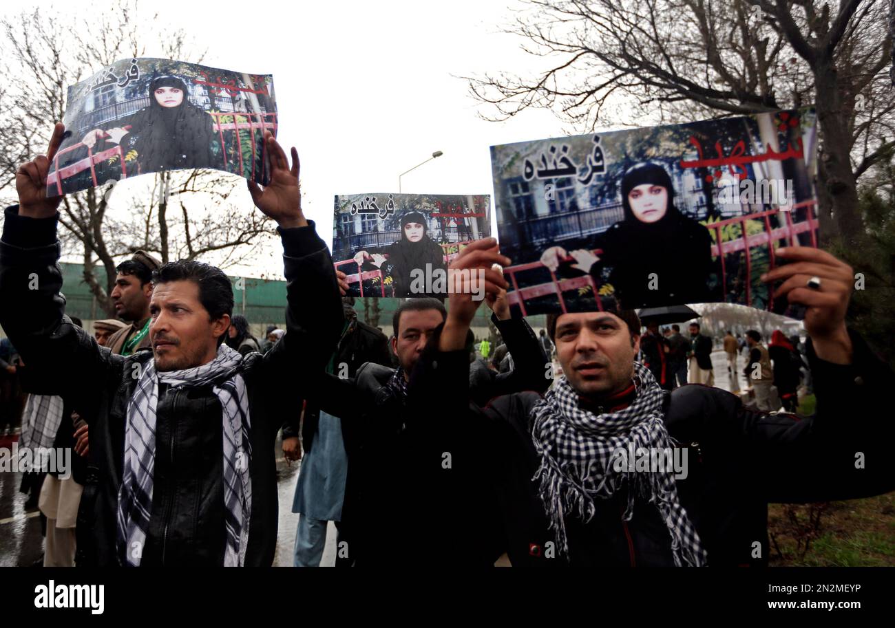 Afghan men hold posters with the photo of Farkhunda and Persian that ...
