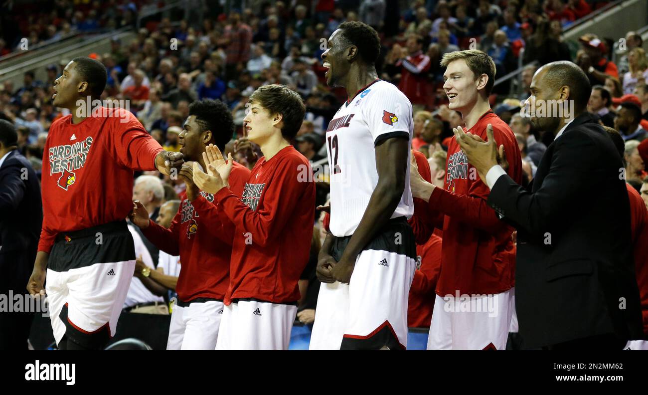 Players on the Louisville bench, including Mangok Mathiang (12 ...