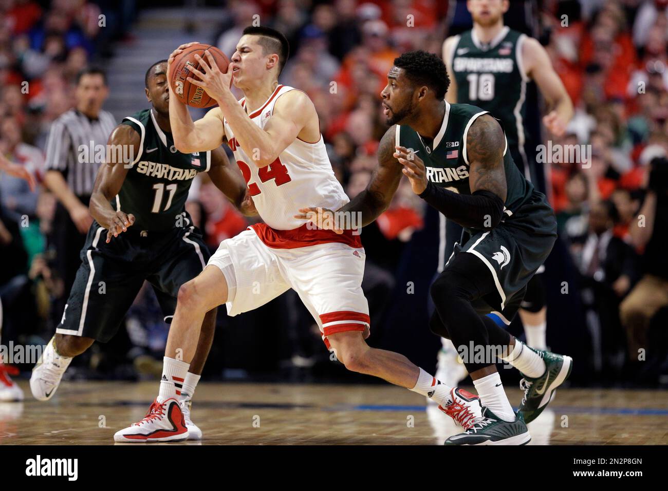 Wisconsin's Bronson Koenig (24), center, is defended by Michigan State ...