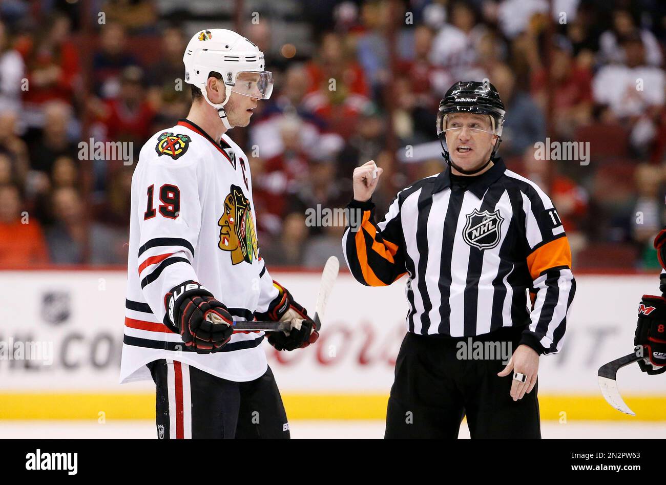 Referee Kelly Sutherland (11) talks with Chicago Blackhawks' Jonathan ...